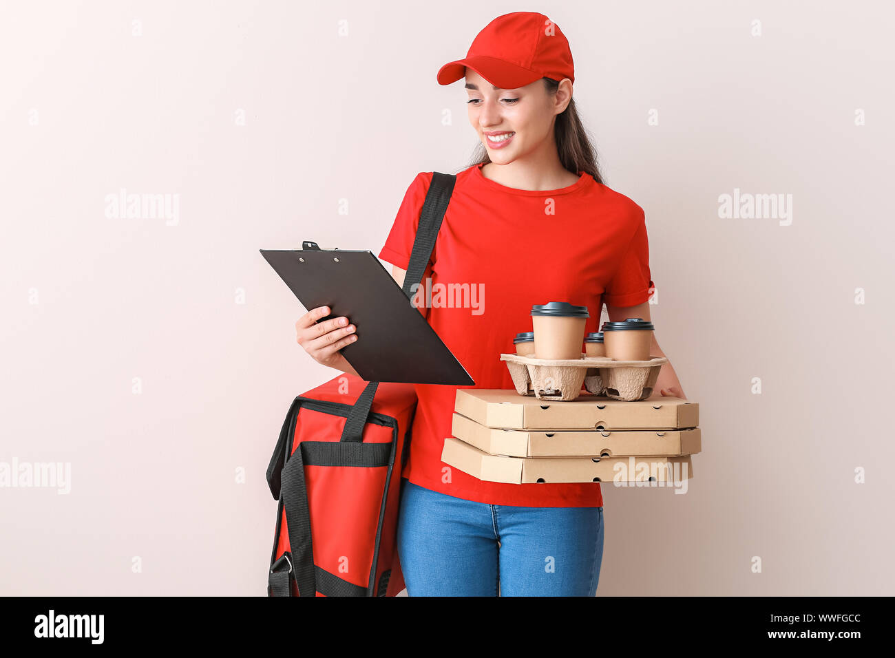 Female worker of food delivery service on white background Stock Photo ...