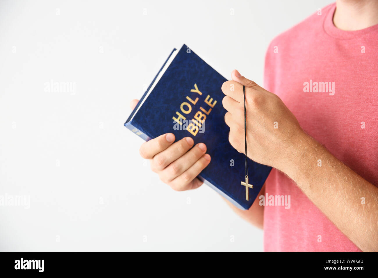 Religious young man praying on white background, closeup Stock Photo ...