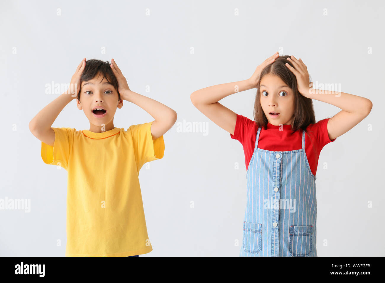Portrait of shocked children on light background Stock Photo - Alamy