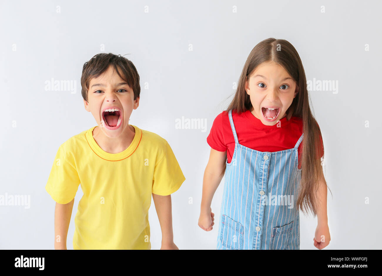 Portrait of screaming children on light background Stock Photo - Alamy