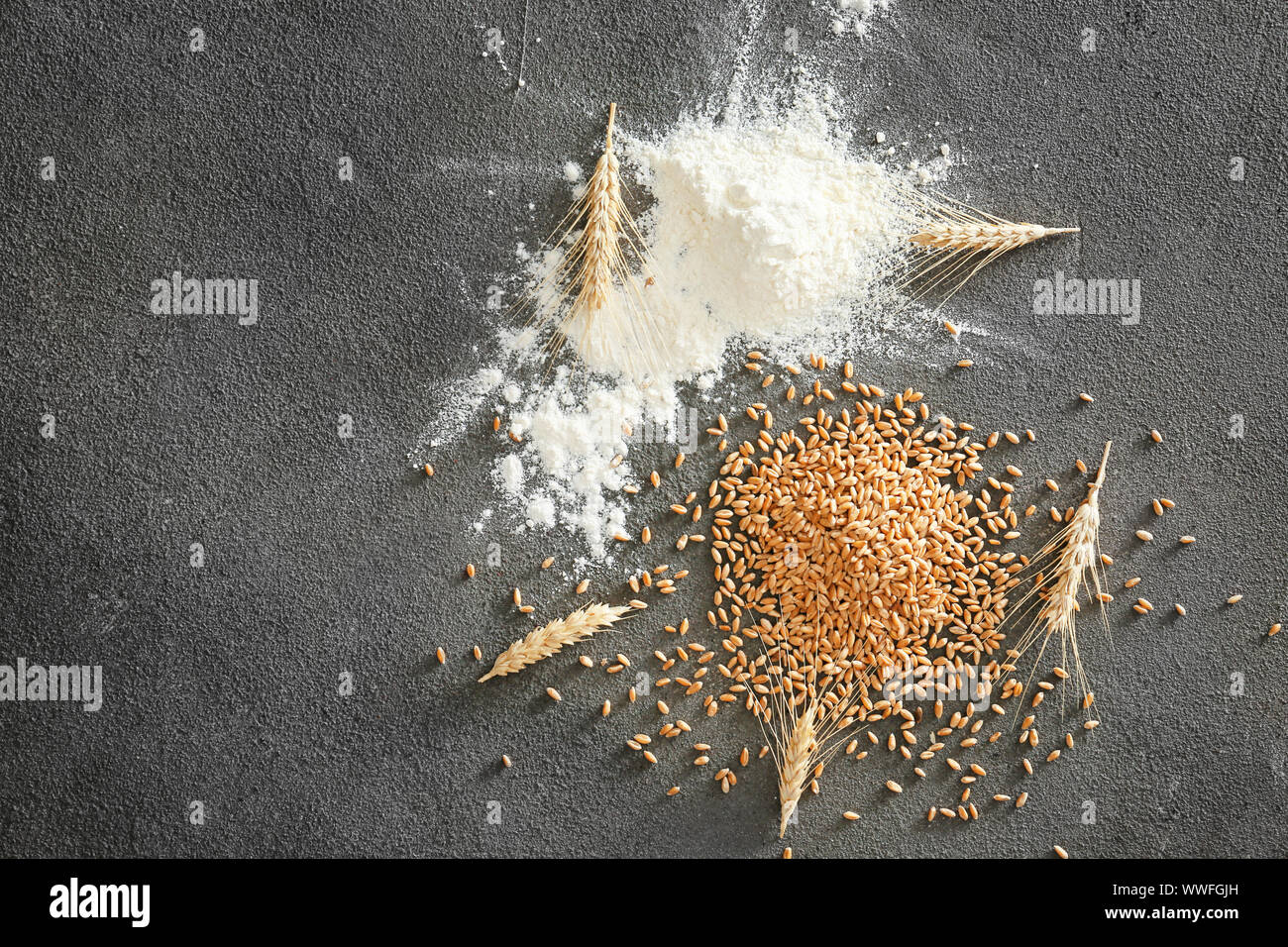 Wheat grains with flour and spikelets on grey background Stock Photo ...