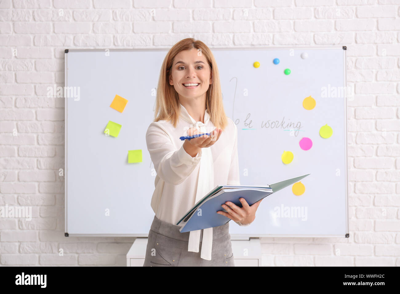 Beautiful English teacher calling out pupil during lesson in classroom ...