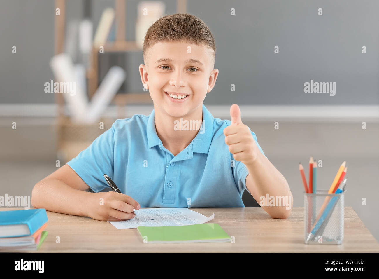 Pupil passing school test in classroom Stock Photo - Alamy
