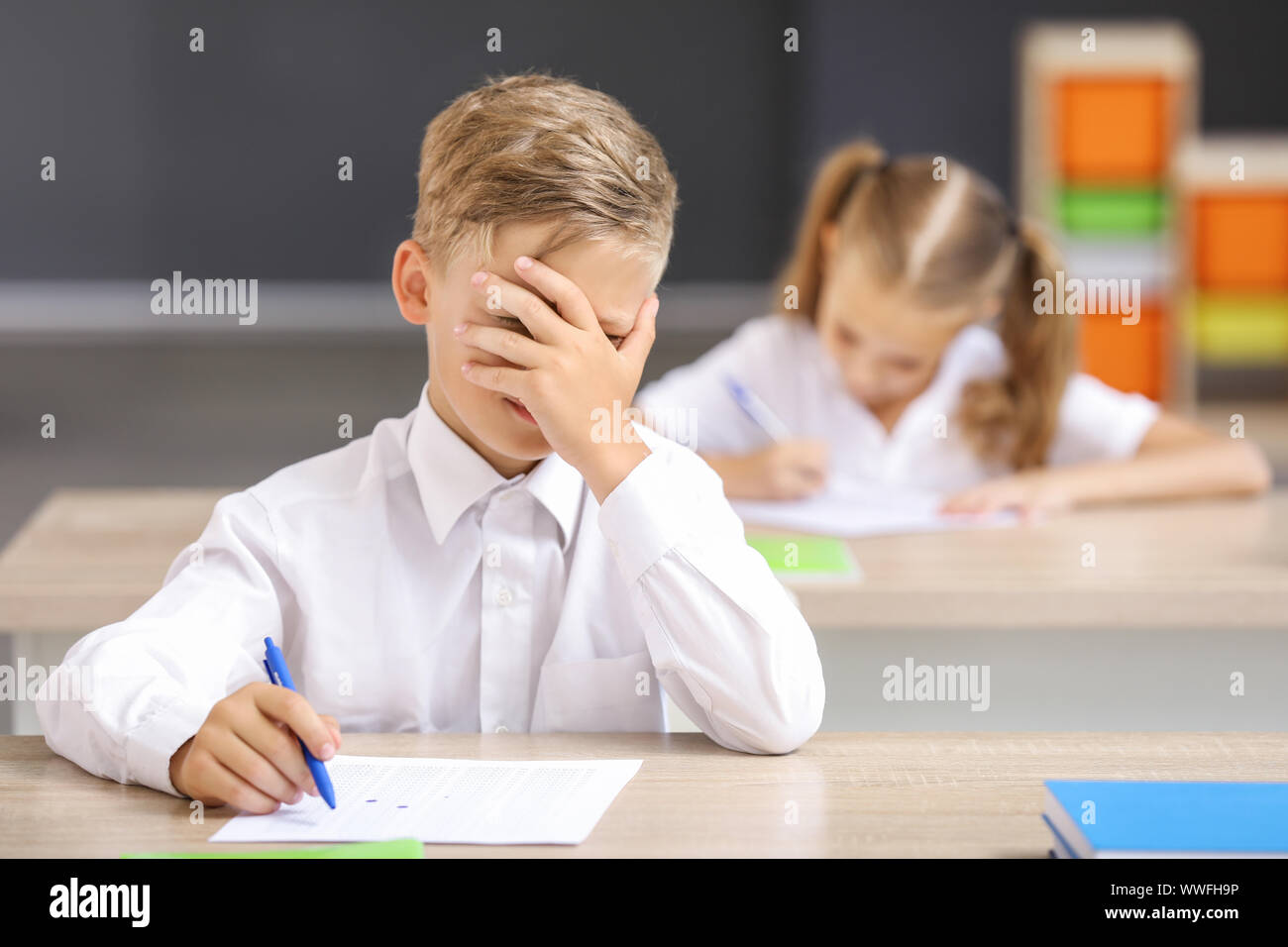 Pupil passing difficult school test in classroom Stock Photo - Alamy