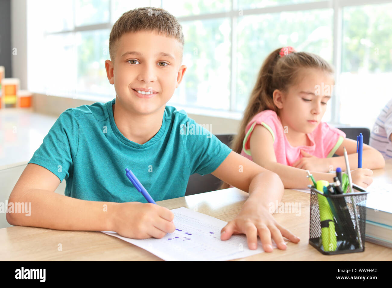 Pupils passing school test in classroom Stock Photo - Alamy