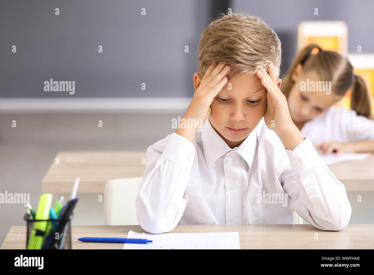 Pupil passing difficult school test in classroom Stock Photo - Alamy