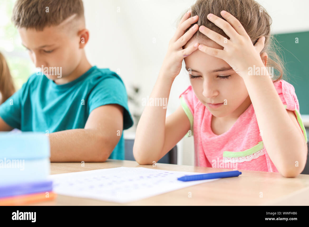 Pupils passing school test in classroom Stock Photo - Alamy