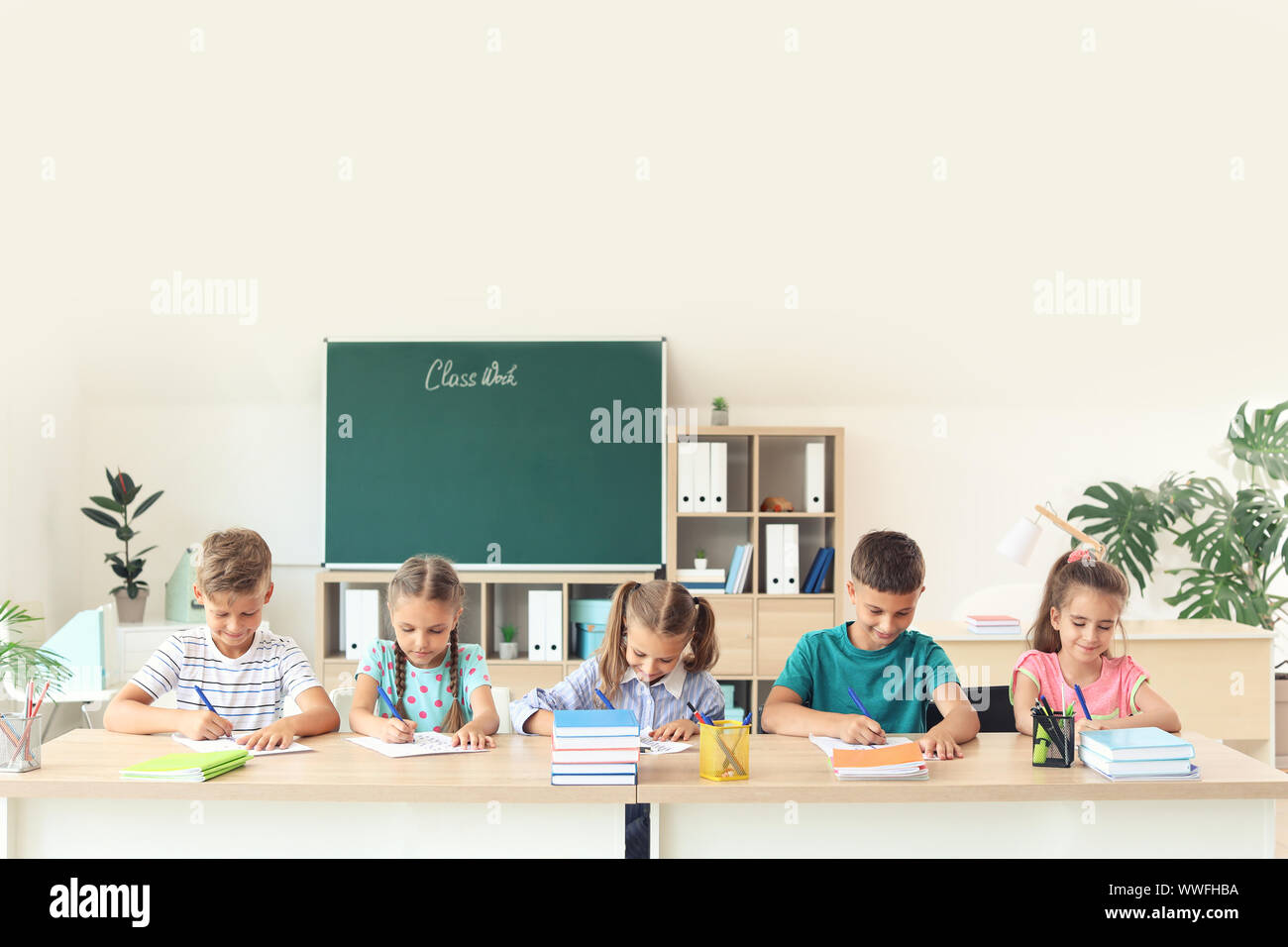 Pupils passing school test in classroom Stock Photo - Alamy