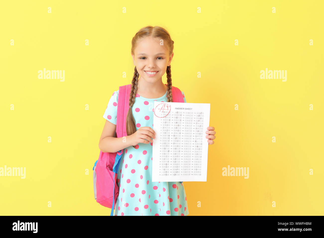 Happy girl with answer sheet for school test on color background Stock ...