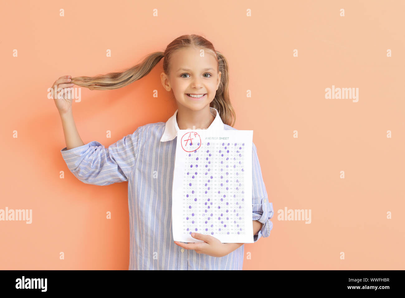 Happy girl with answer sheet for school test on color background Stock ...
