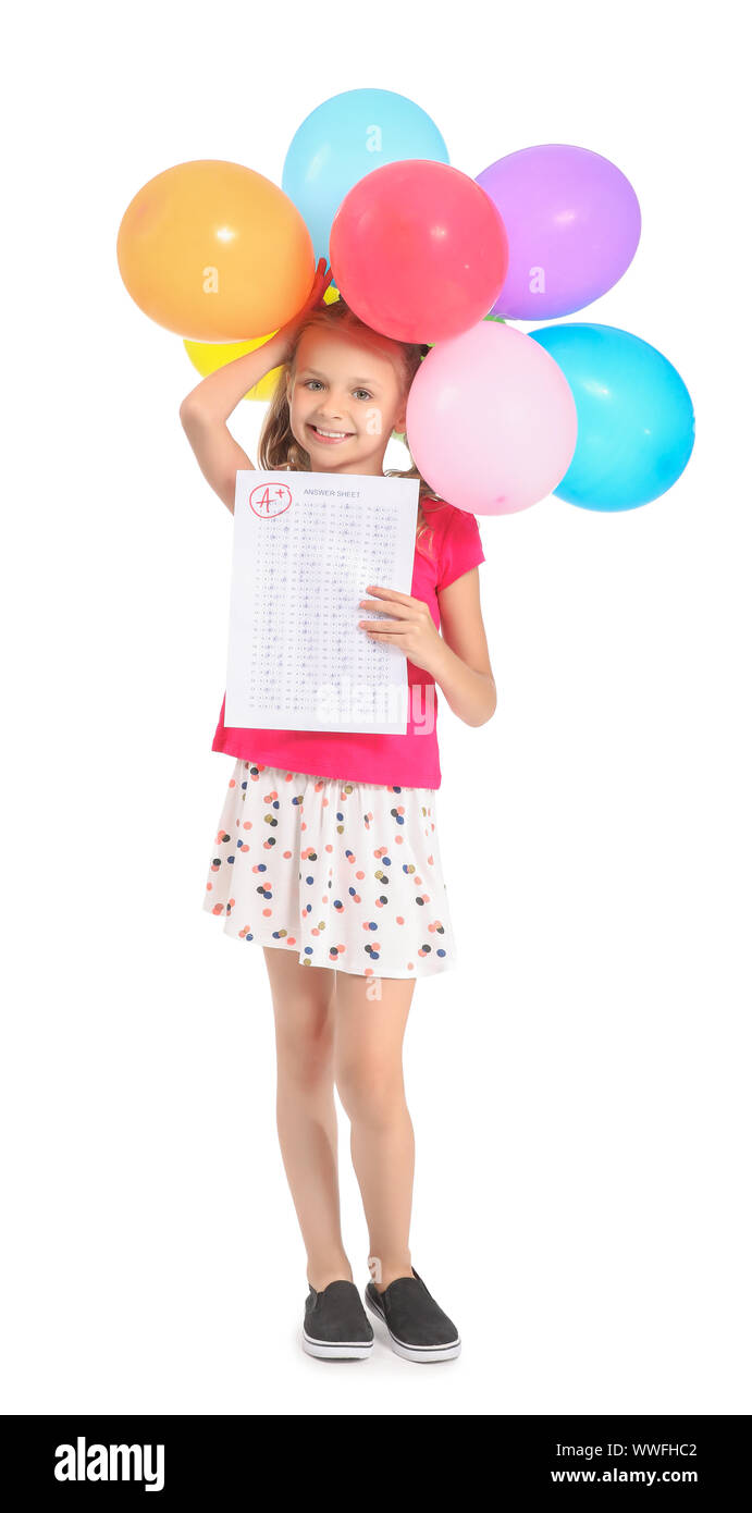 Happy girl with answer sheet for school test and balloons on white ...