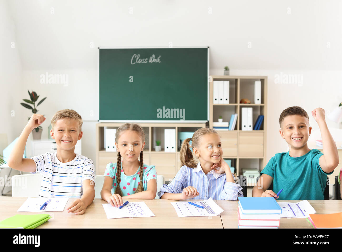 Pupils after successful passing of school test in classroom Stock Photo ...