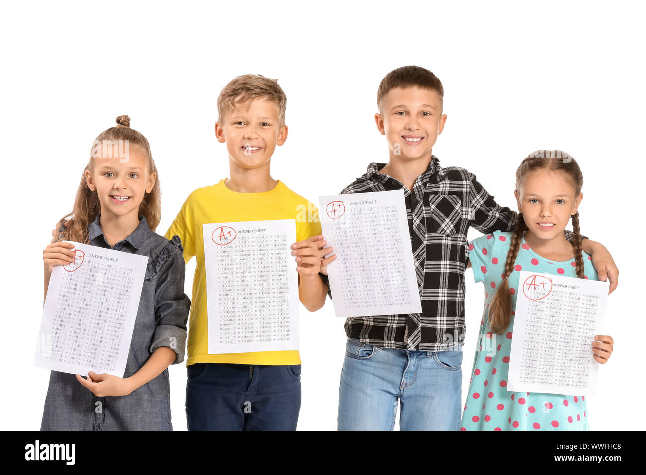 Happy children with answer sheets for school test on white background ...