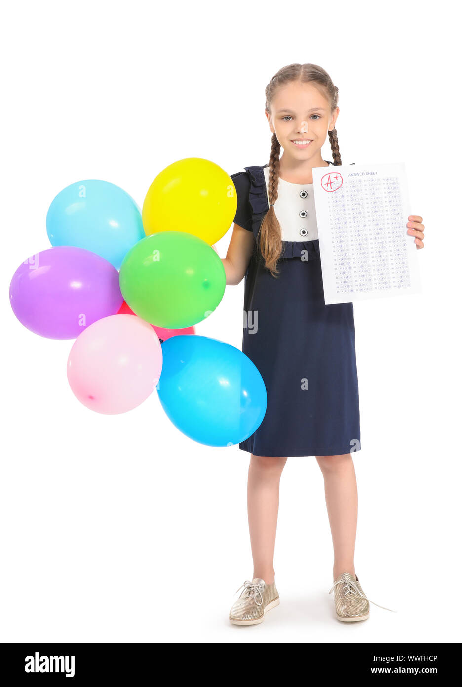 Happy girl with answer sheet for school test and balloons on white ...