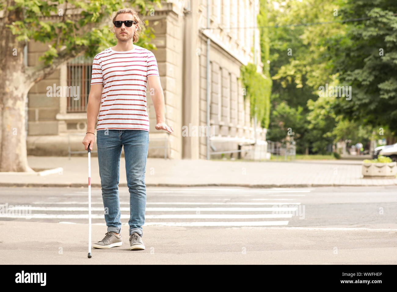 Blind young man walking outdoors Stock Photo - Alamy