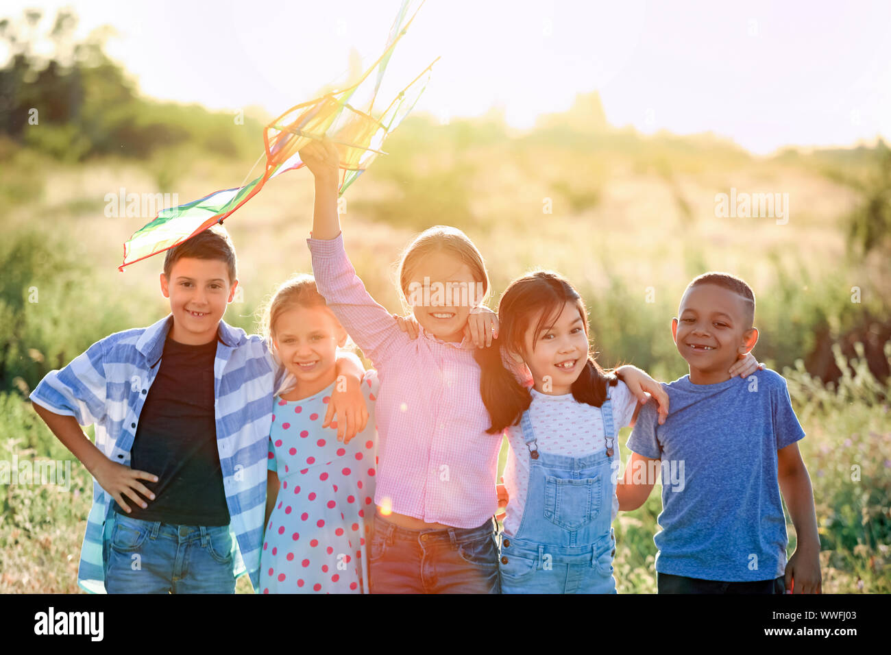 Little children flying kite in field Stock Photo - Alamy