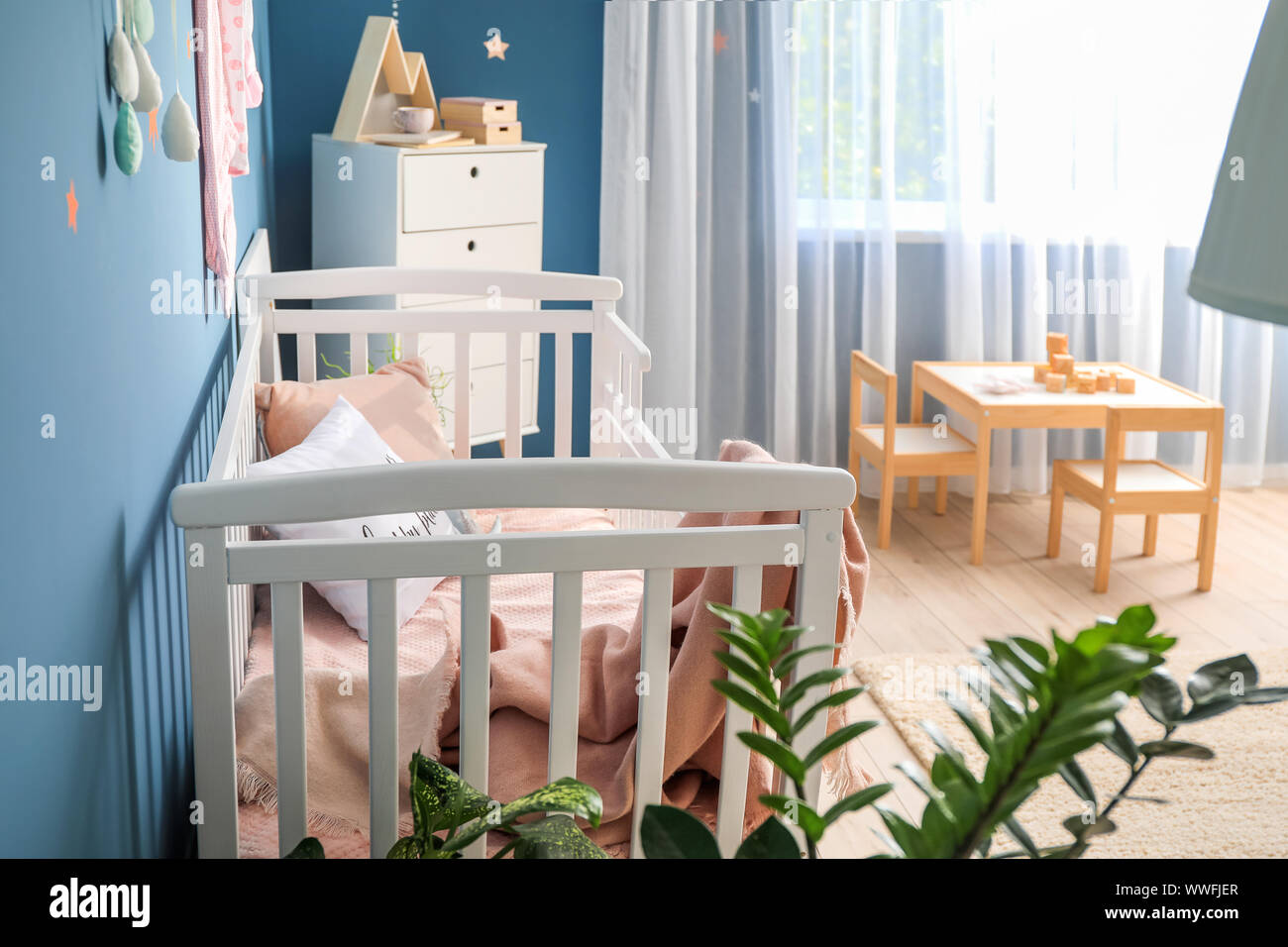 Stylish baby bed in modern interior of children's room Stock Photo - Alamy