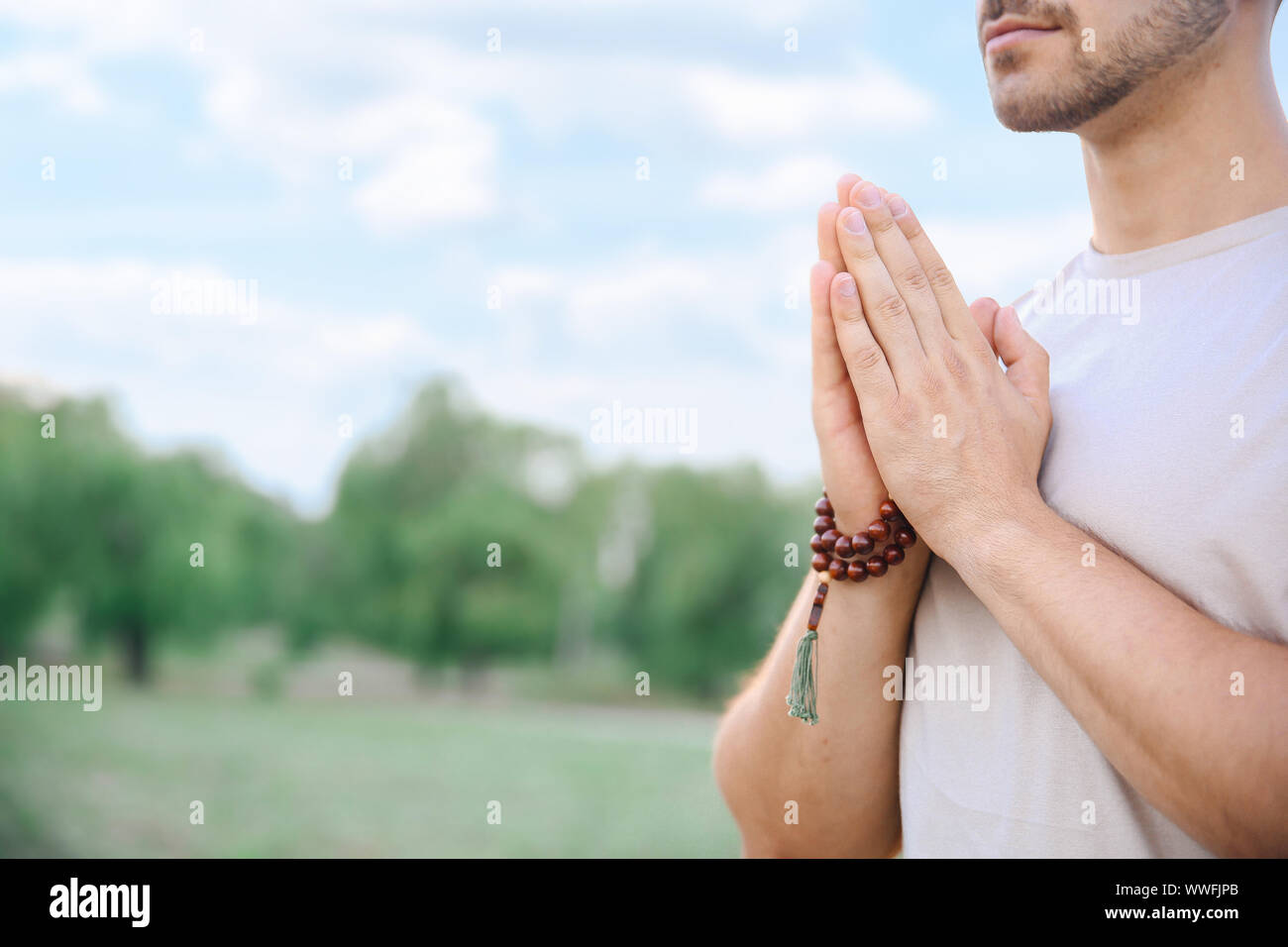 Young man praying to God outdoors Stock Photo - Alamy