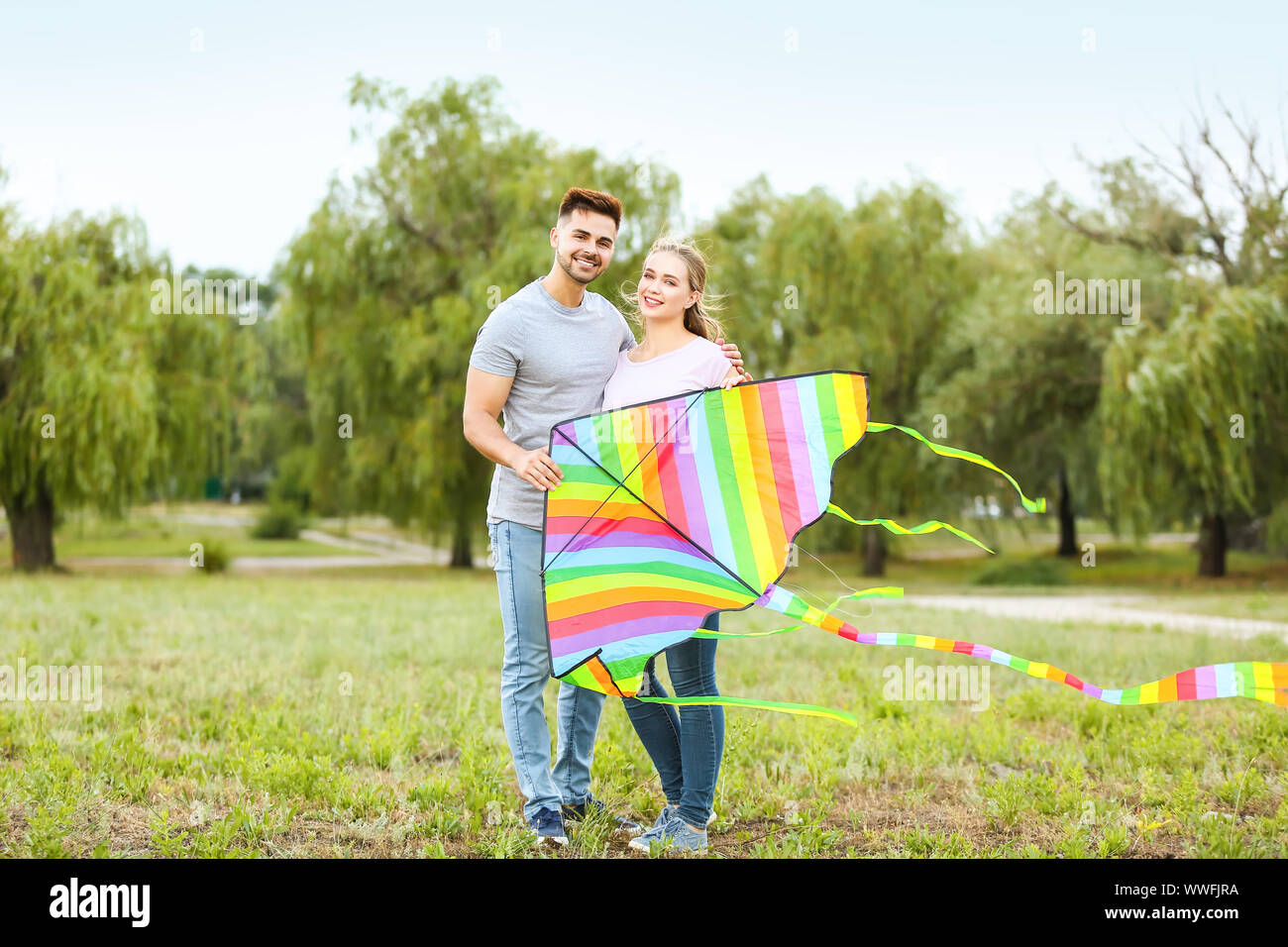 Happy young couple with kite outdoors Stock Photo - Alamy