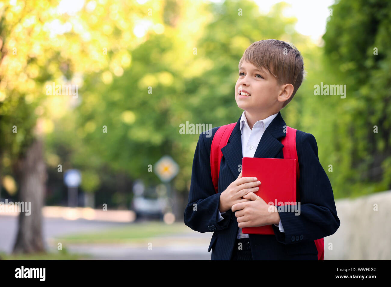 Cute little pupil after classes outdoors Stock Photo - Alamy