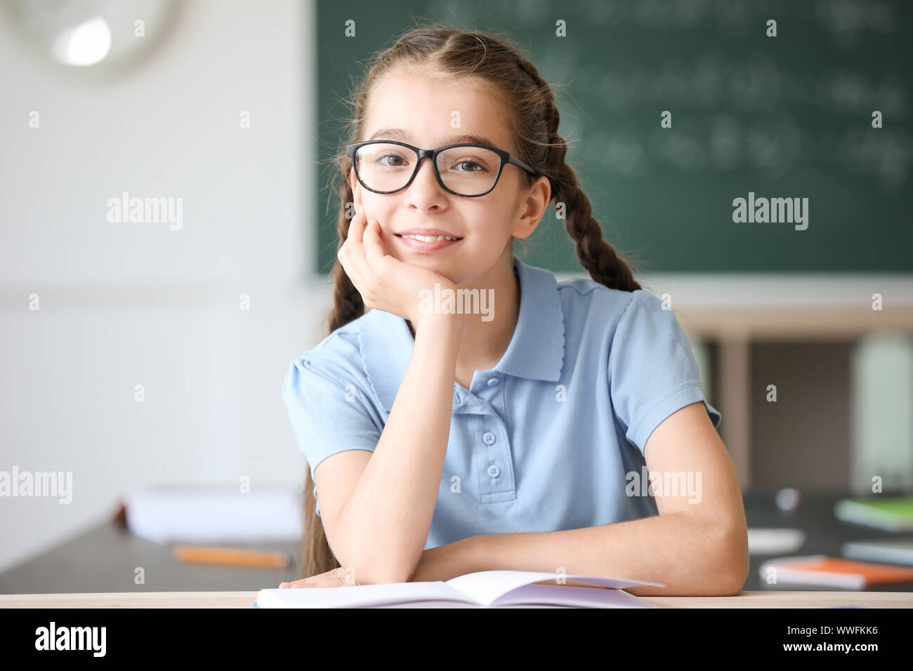 Cute little girl during lesson in classroom Stock Photo - Alamy
