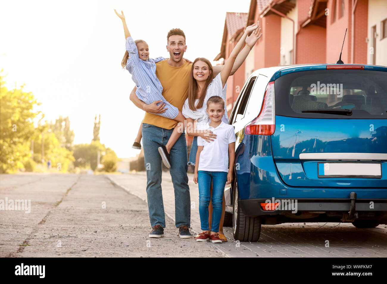 Happy family near car outdoors Stock Photo - Alamy