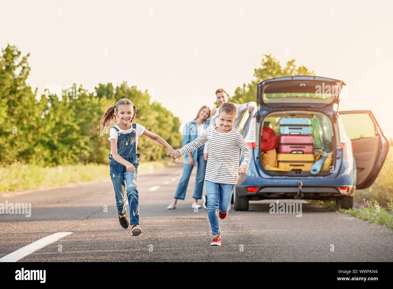 Happy children and their parents near car outdoors Stock Photo - Alamy