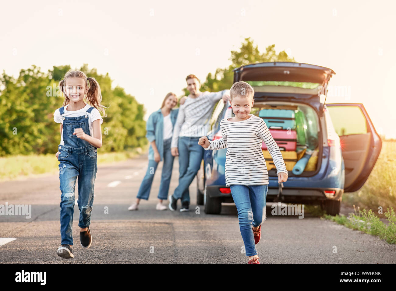 Happy children and their parents near car outdoors Stock Photo - Alamy