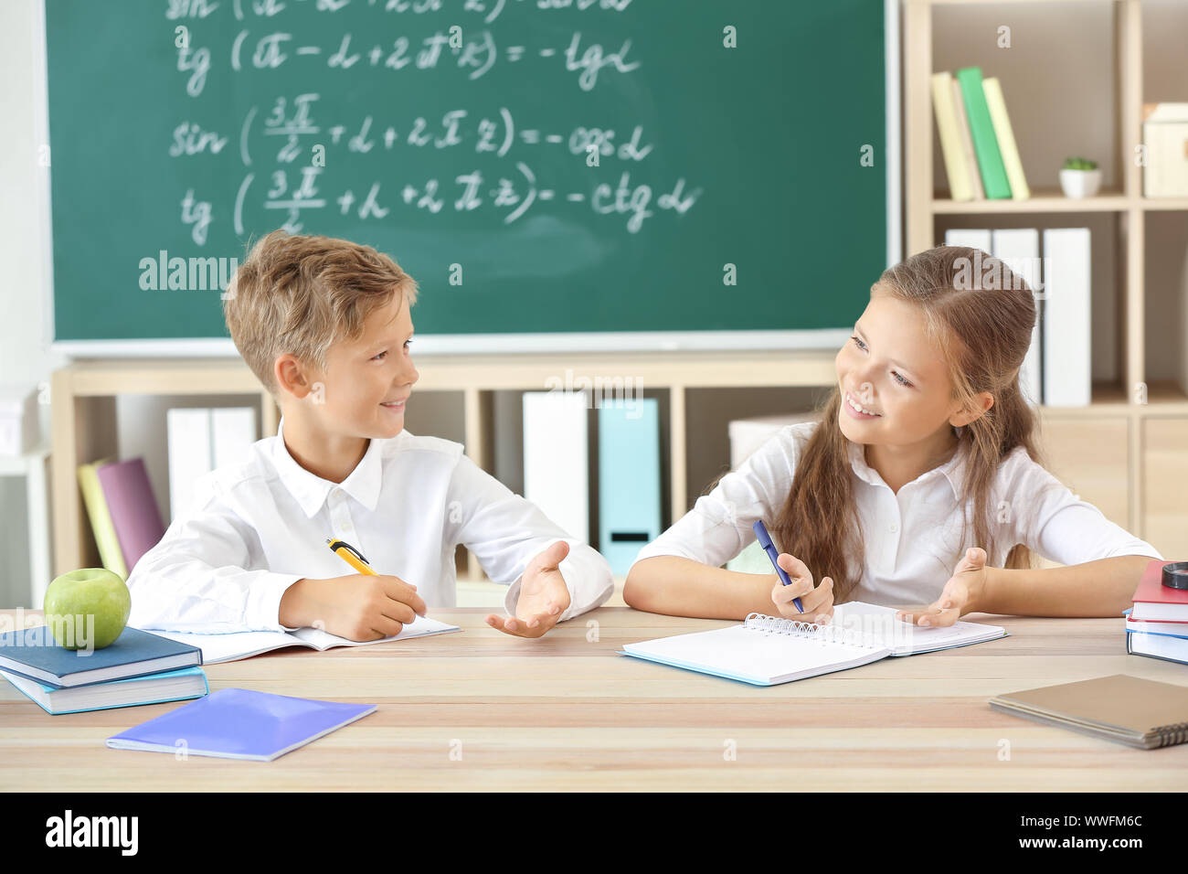 Little pupils doing lessons in classroom Stock Photo - Alamy