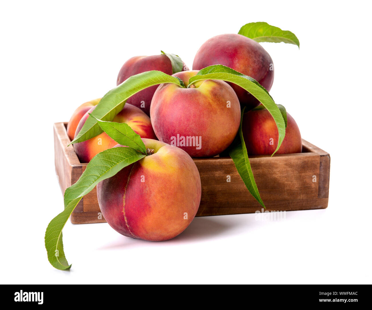 Box with ripe peaches on white background Stock Photo - Alamy