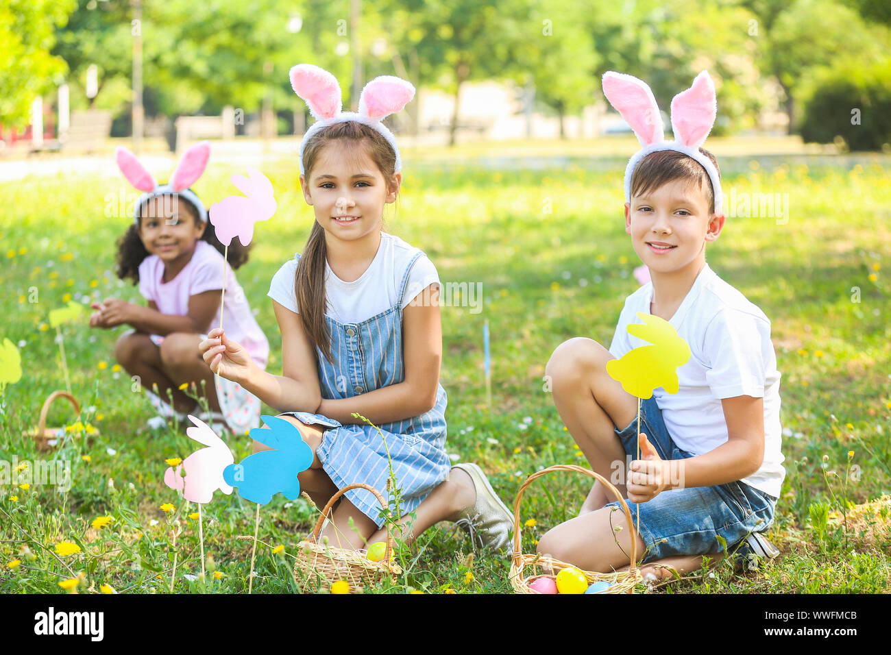 Little children gathering Easter eggs in park Stock Photo - Alamy