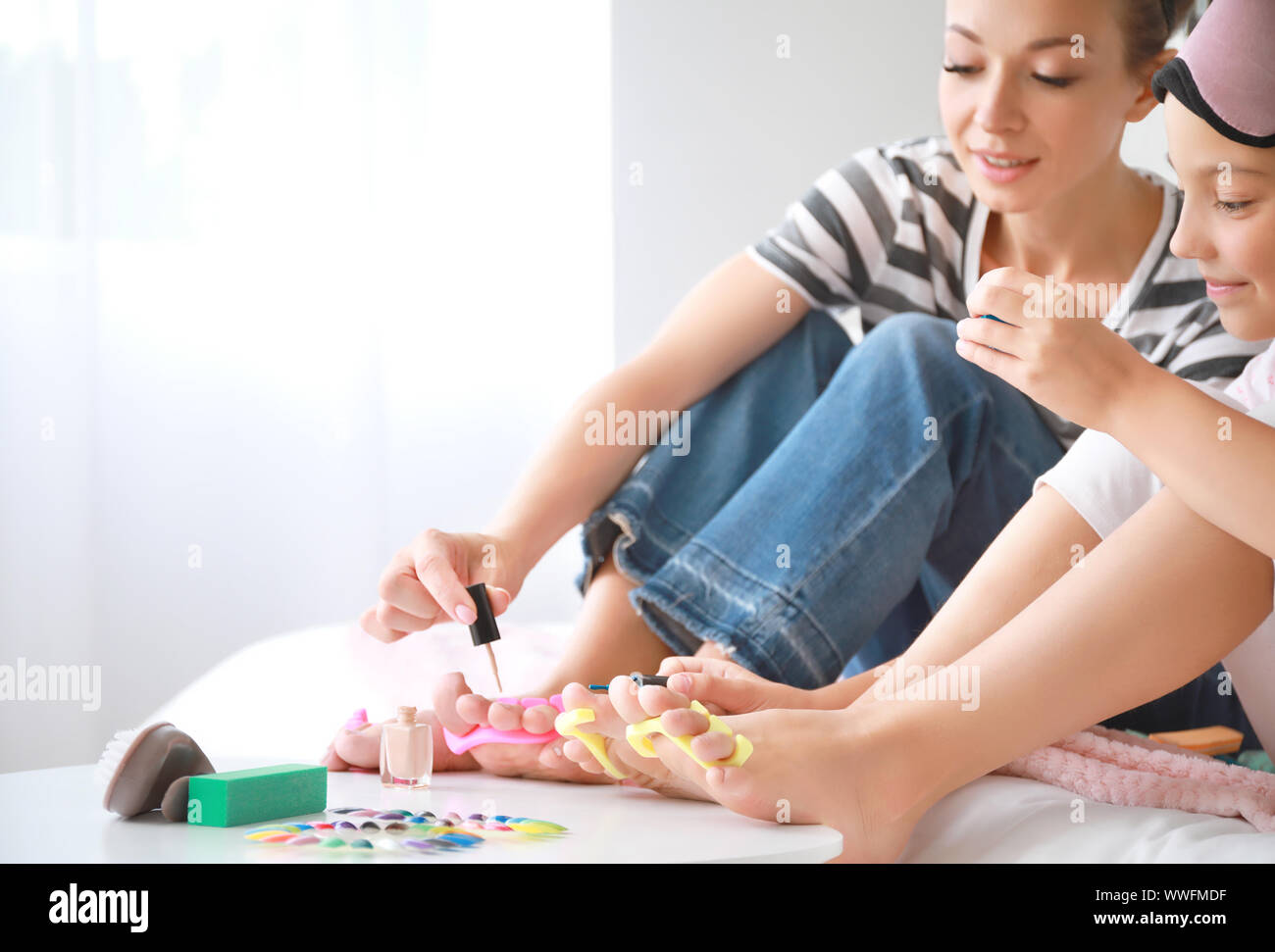 Little daughter with mother making pedicure at home Stock Photo - Alamy