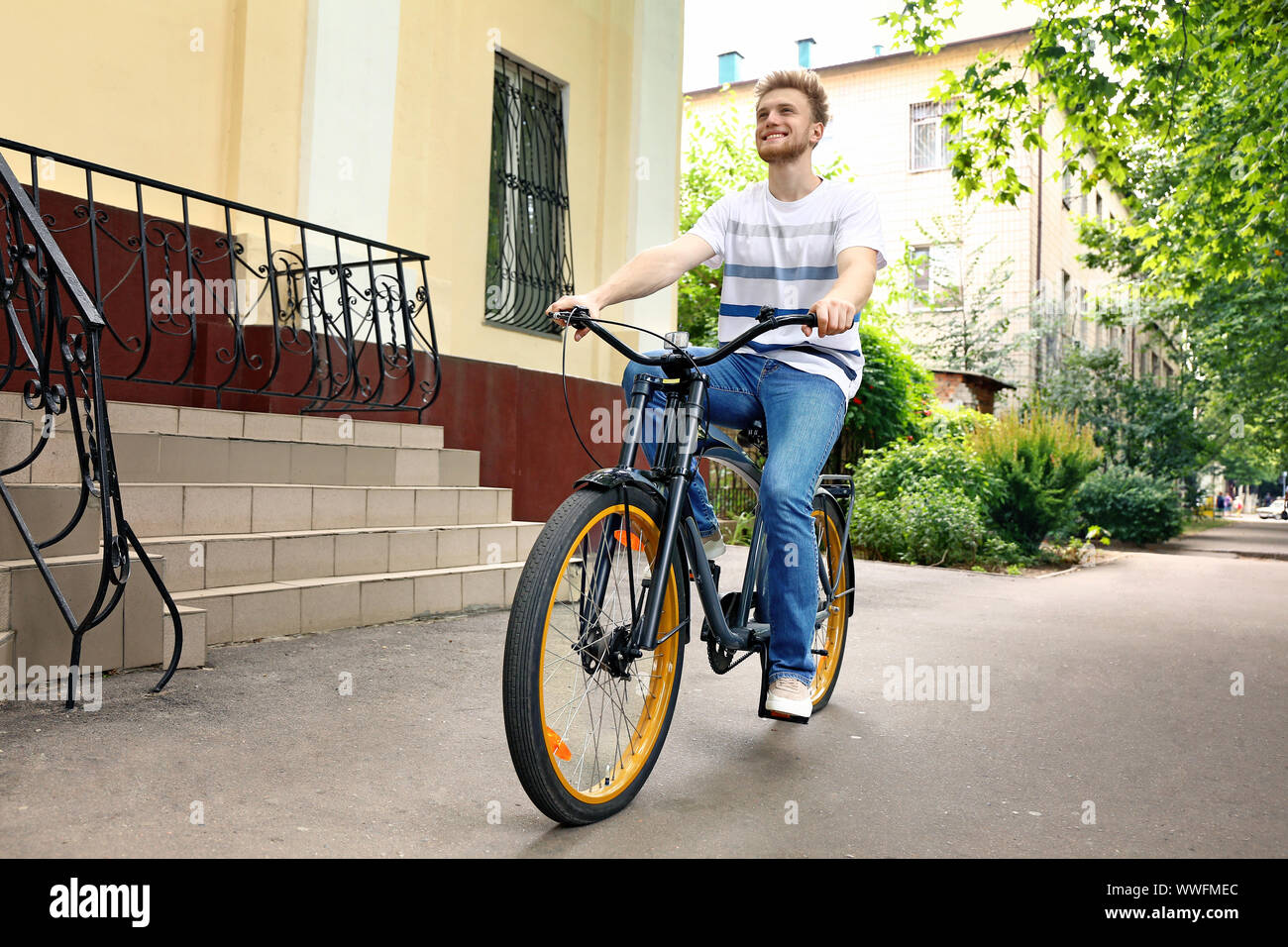 Young man riding bicycle outdoors Stock Photo - Alamy