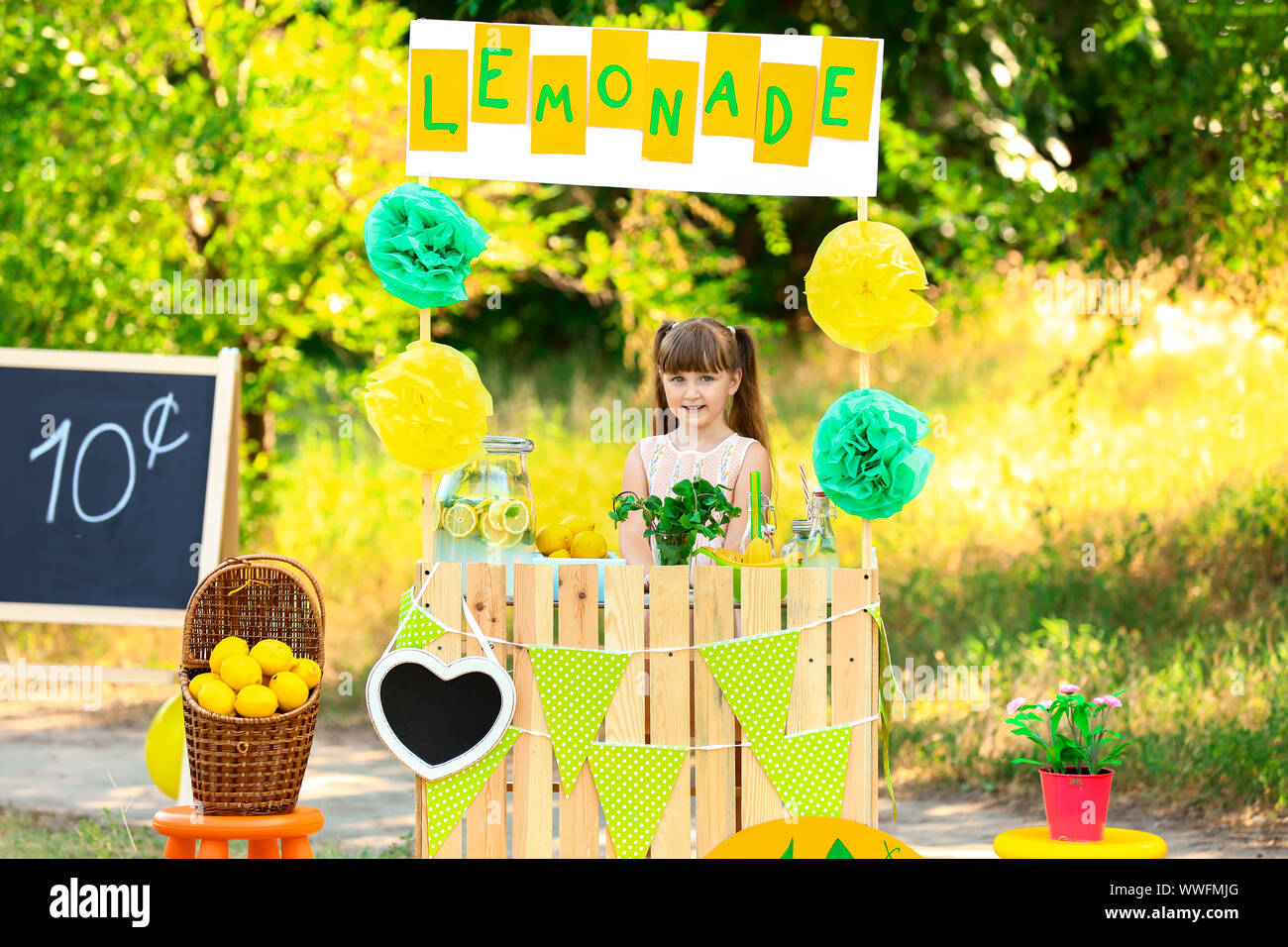 Cute little girl at lemonade stand in park Stock Photo - Alamy