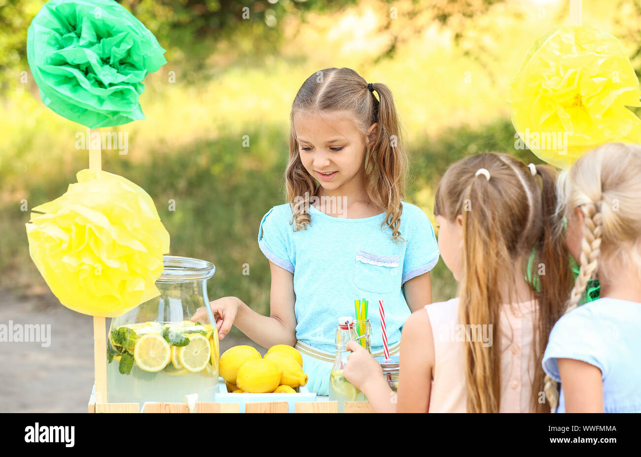 Cute little girl selling lemonade in park Stock Photo - Alamy