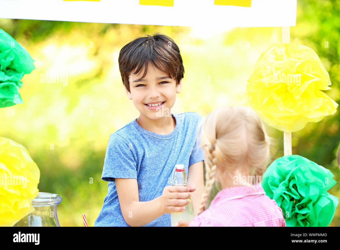 Cute little boy selling lemonade in park Stock Photo - Alamy
