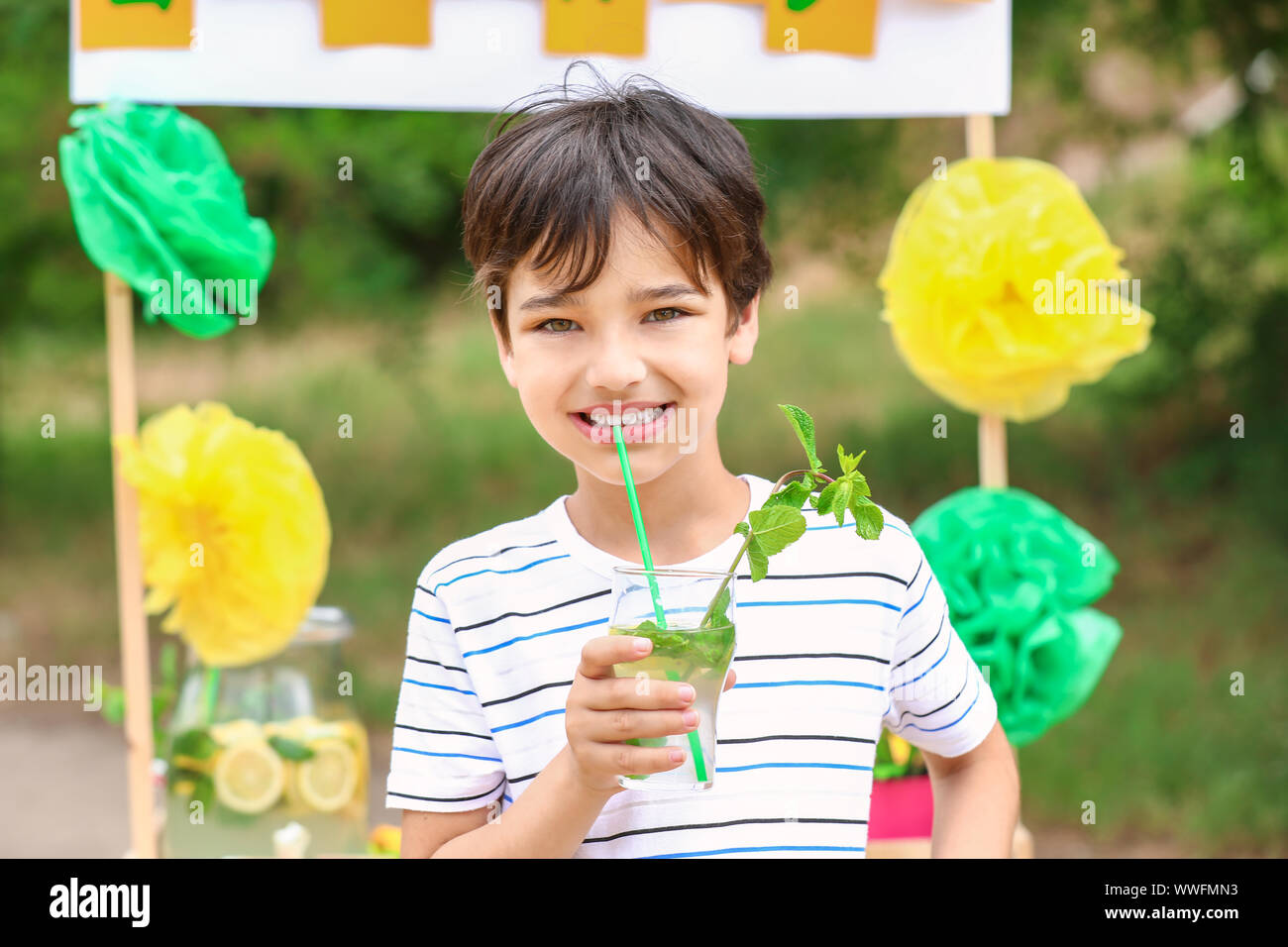 Cute little boy drinking lemonade in park Stock Photo - Alamy