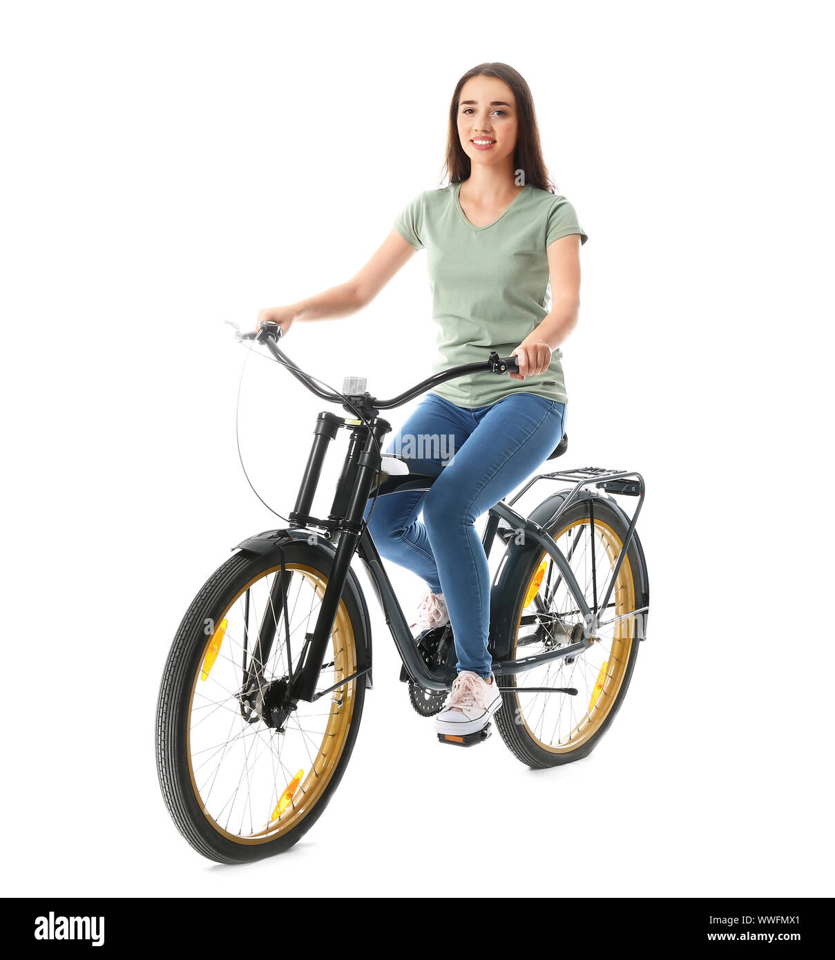 Beautiful young woman riding bicycle against white background Stock ...