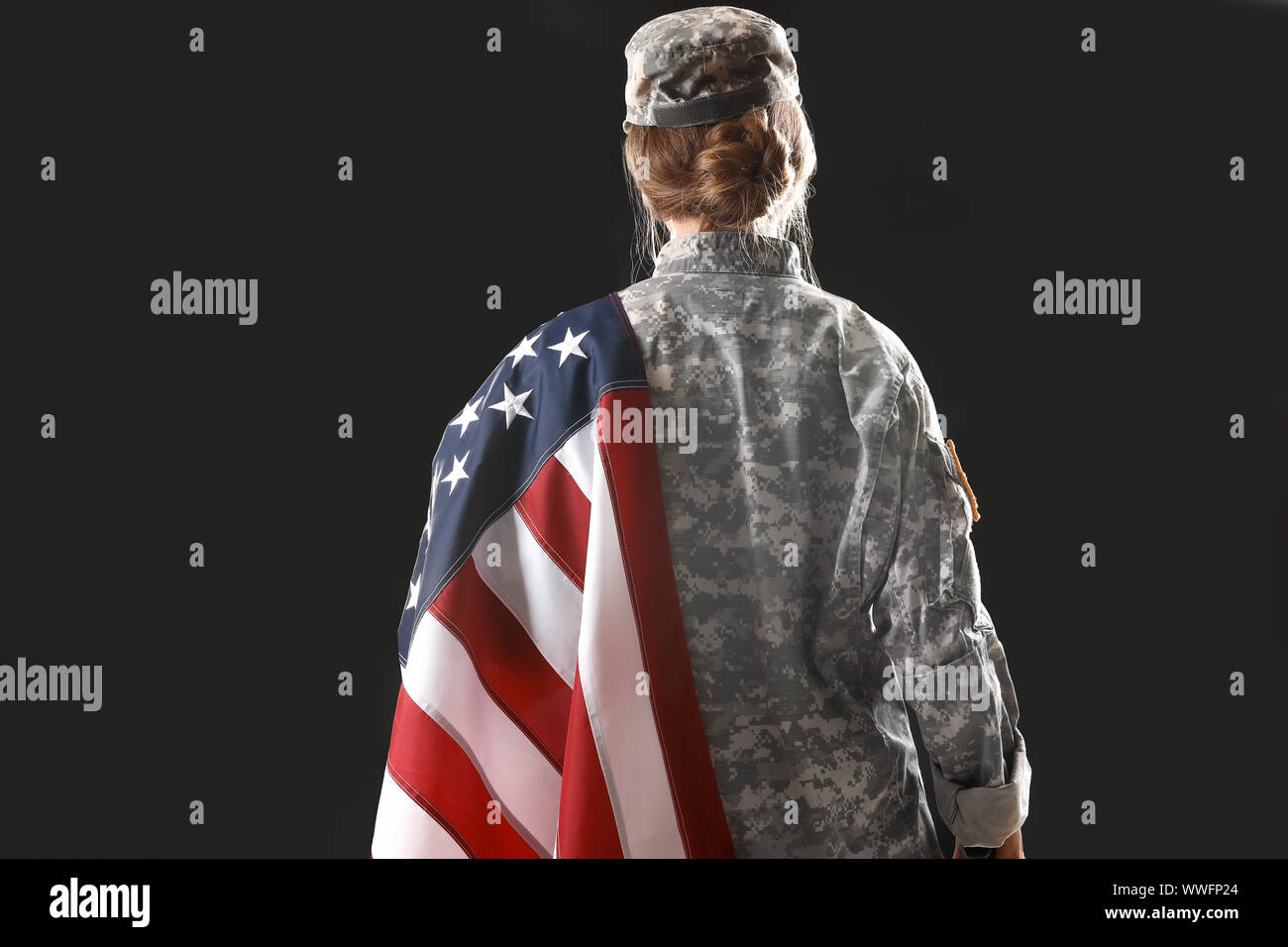 Young female soldier with USA flag on dark background, back view Stock ...