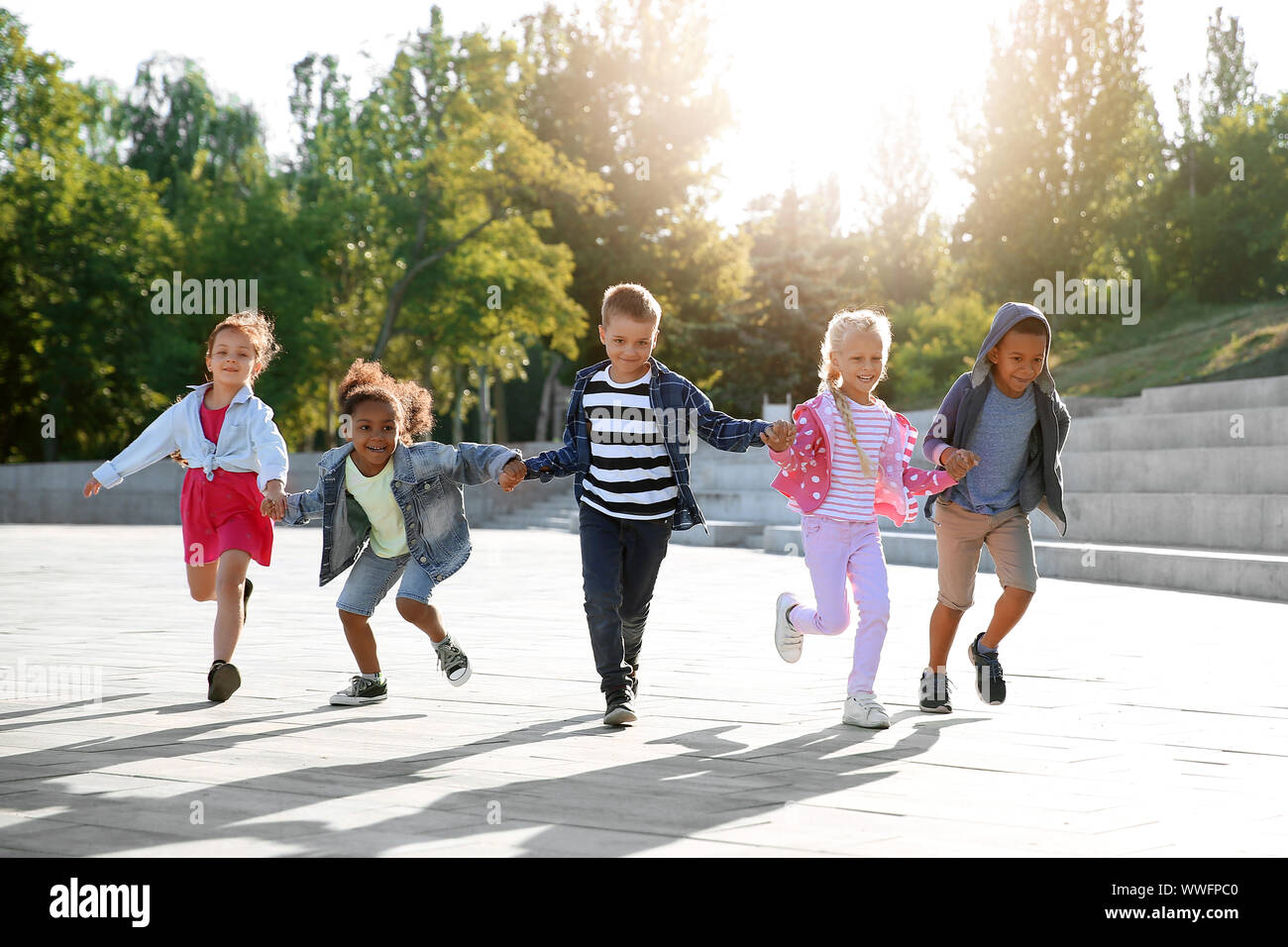 Group of running children outdoors Stock Photo - Alamy