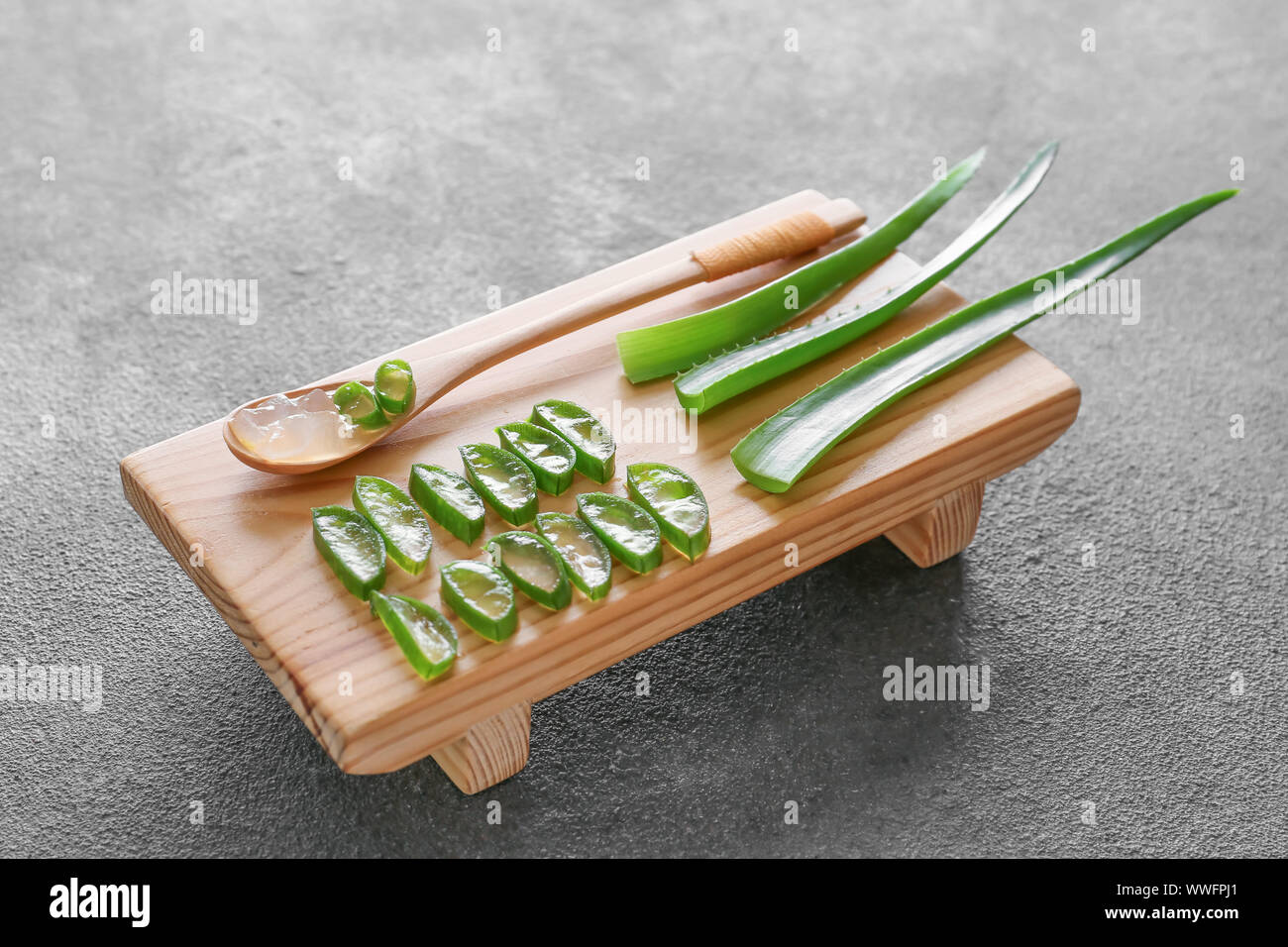 Stand with aloe vera on grey background Stock Photo - Alamy
