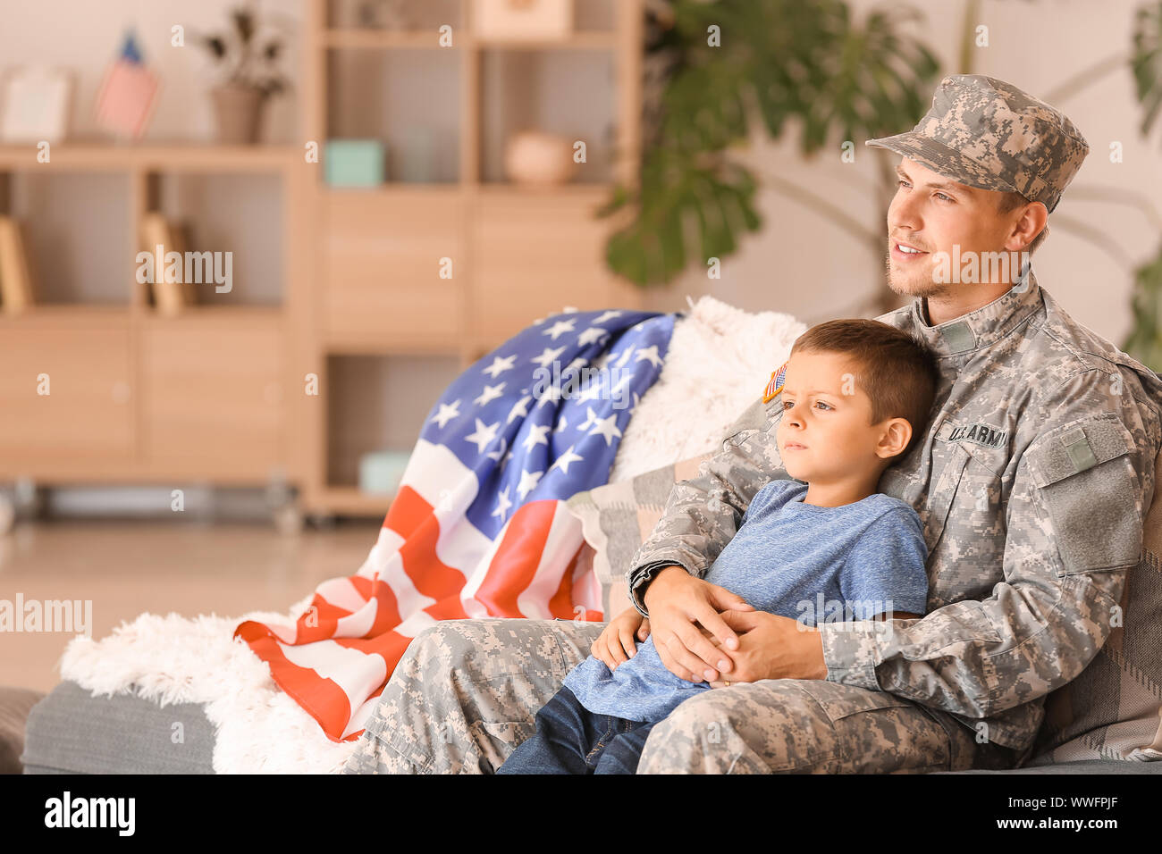Happy military man with his son at home Stock Photo - Alamy