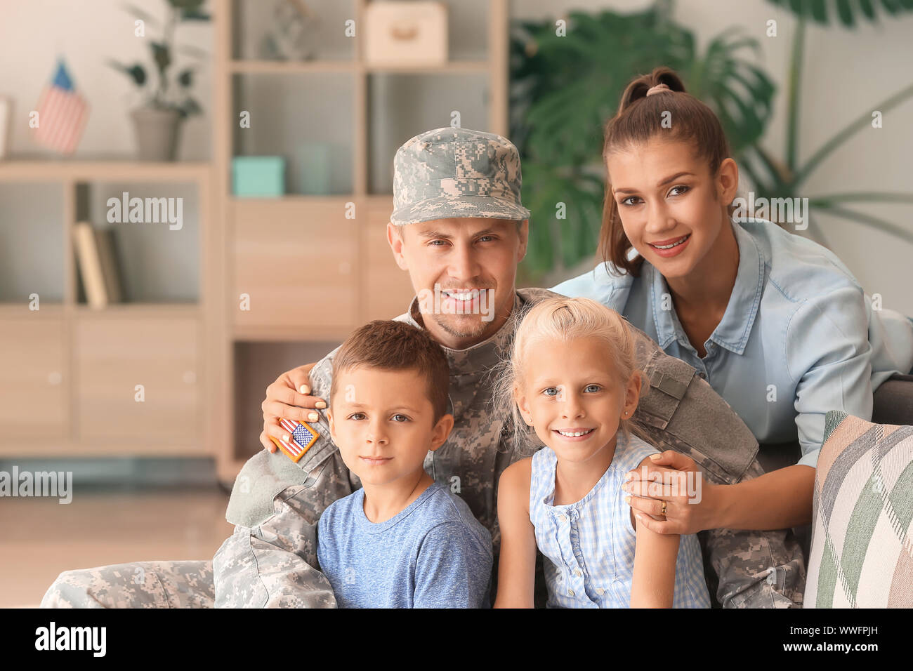 Happy military man with his family at home Stock Photo - Alamy