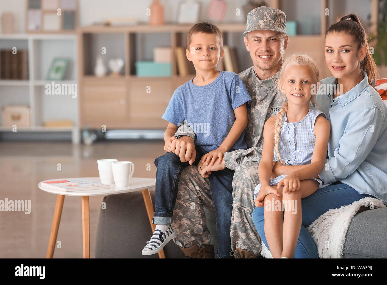Happy military man with his family at home Stock Photo - Alamy