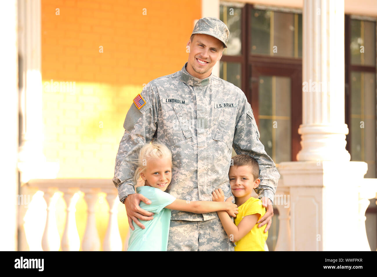 Happy military man with his children outdoors Stock Photo - Alamy