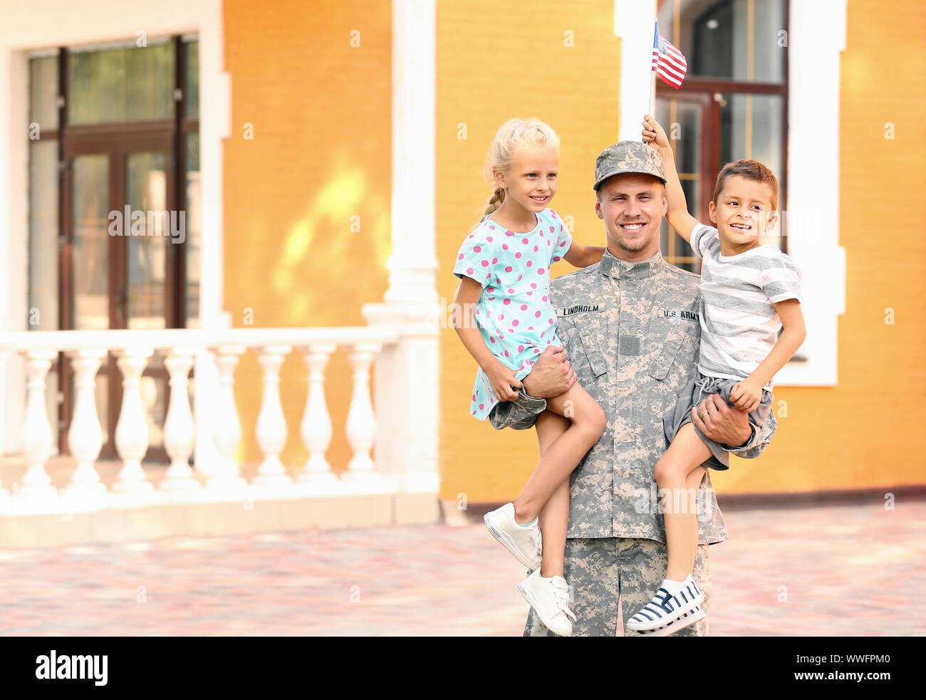 Happy military man with his children outdoors Stock Photo - Alamy