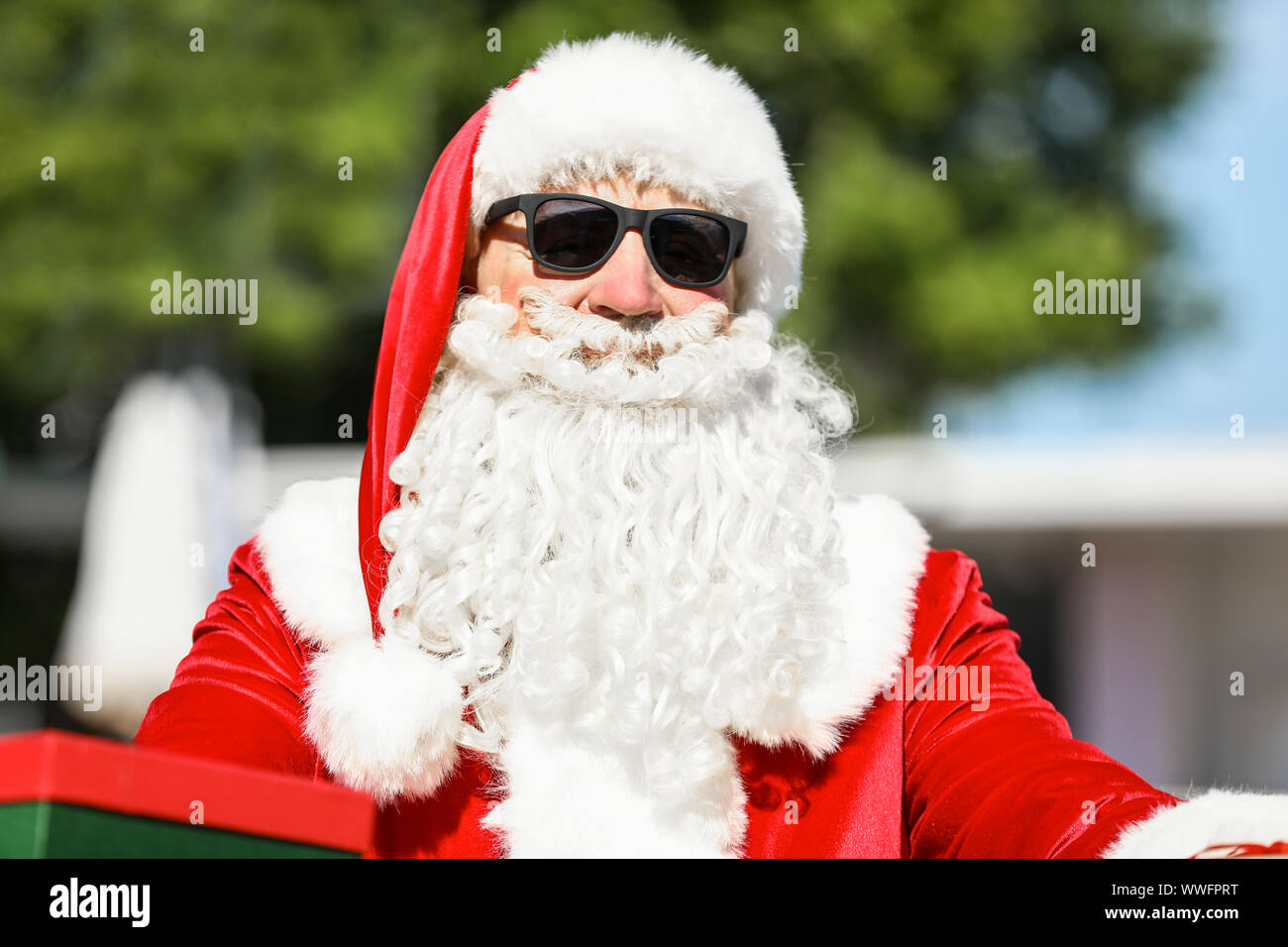 Cool Santa Claus with gifts at resort Stock Photo - Alamy