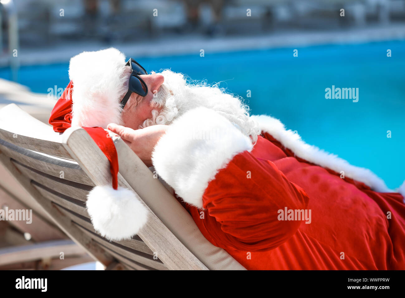 Santa Claus resting near swimming pool at resort Stock Photo - Alamy