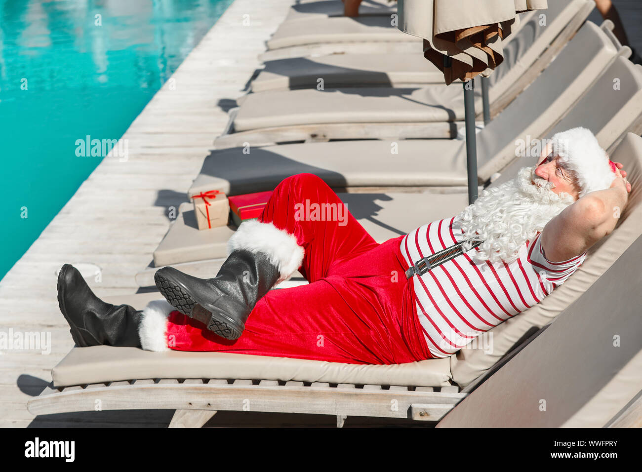 Santa Claus resting near swimming pool at resort Stock Photo - Alamy