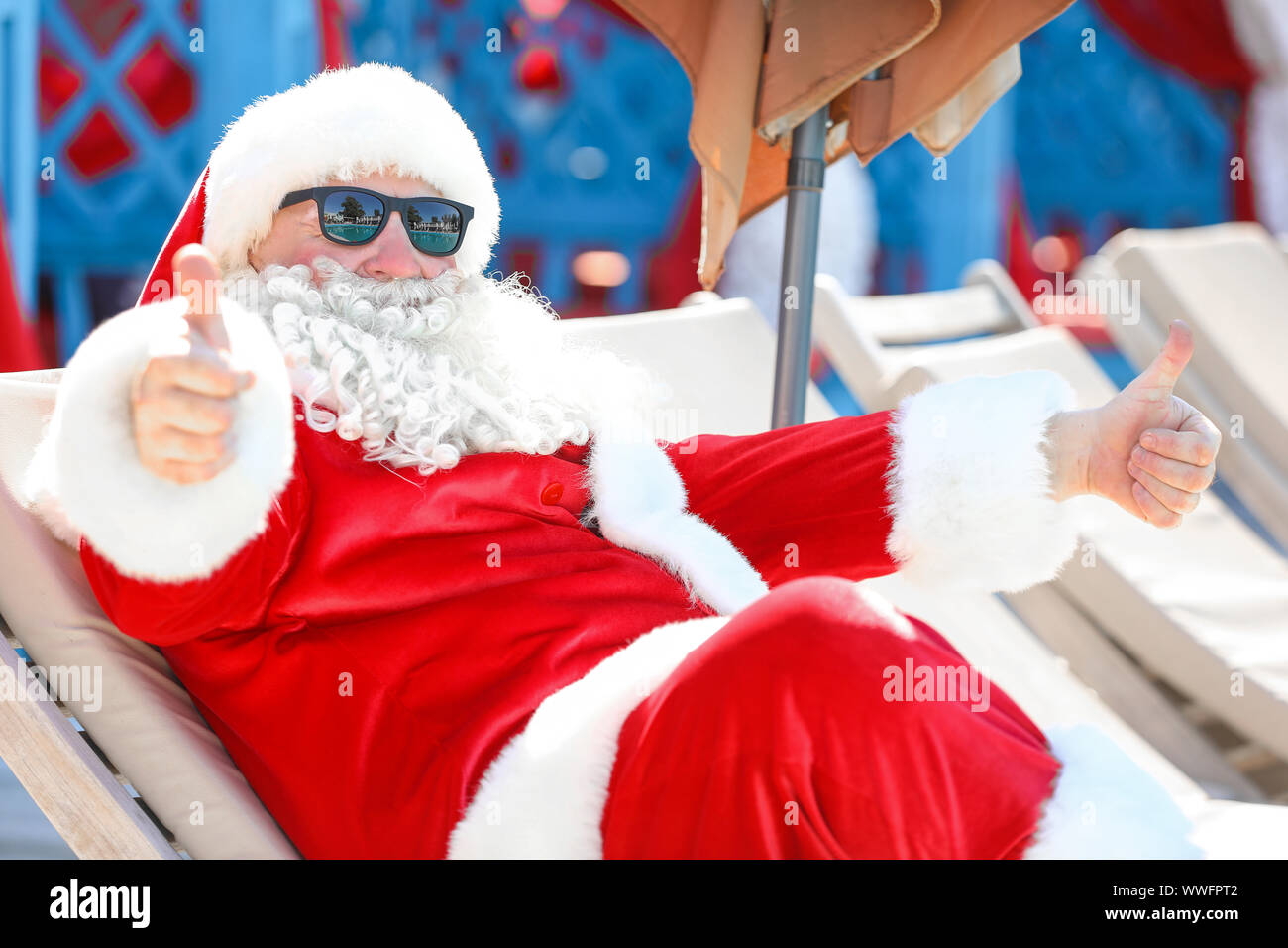 Cool Santa Claus resting on sun lounger at resort Stock Photo - Alamy